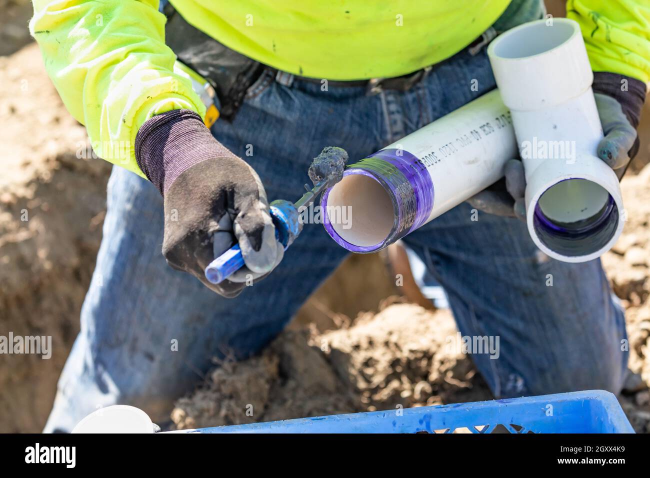 Plumber Applying Pipe Cleaner, Primer and Glue to PVC Pipe At ...