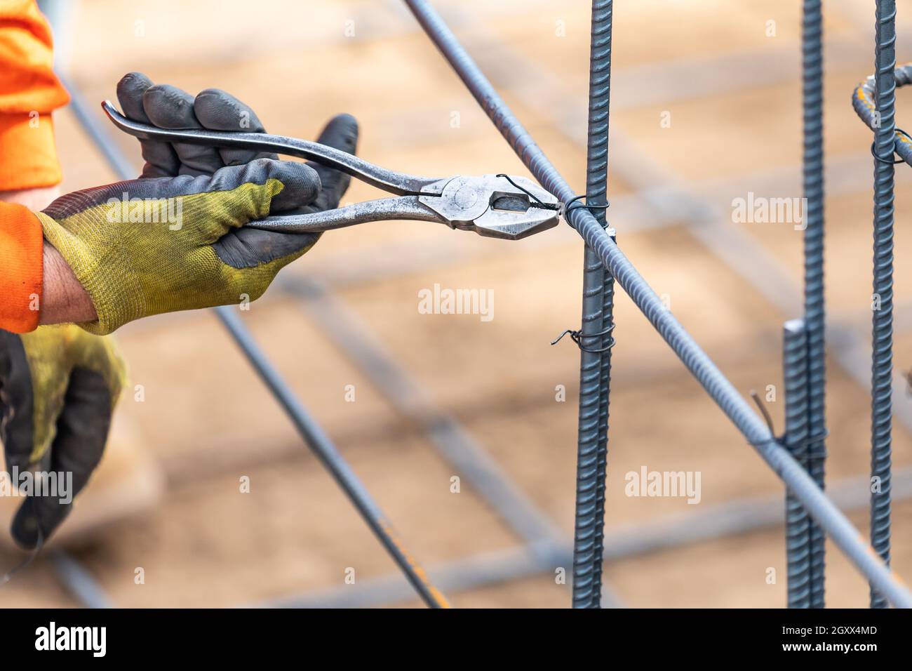 Worker Securing Steel Rebar Framing With Wire Plier Cutter Tool At ...