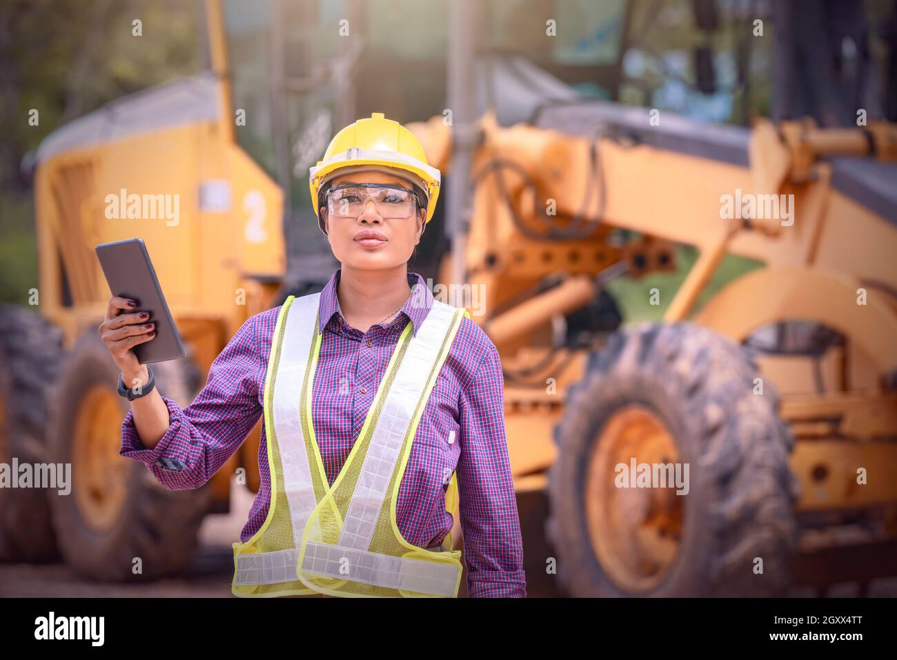 Woman engineers construction worker checking layout on digital ipad ...