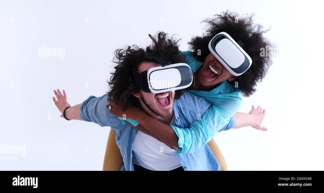 Happy multiethnic couple getting experience using VR headset glasses of ...