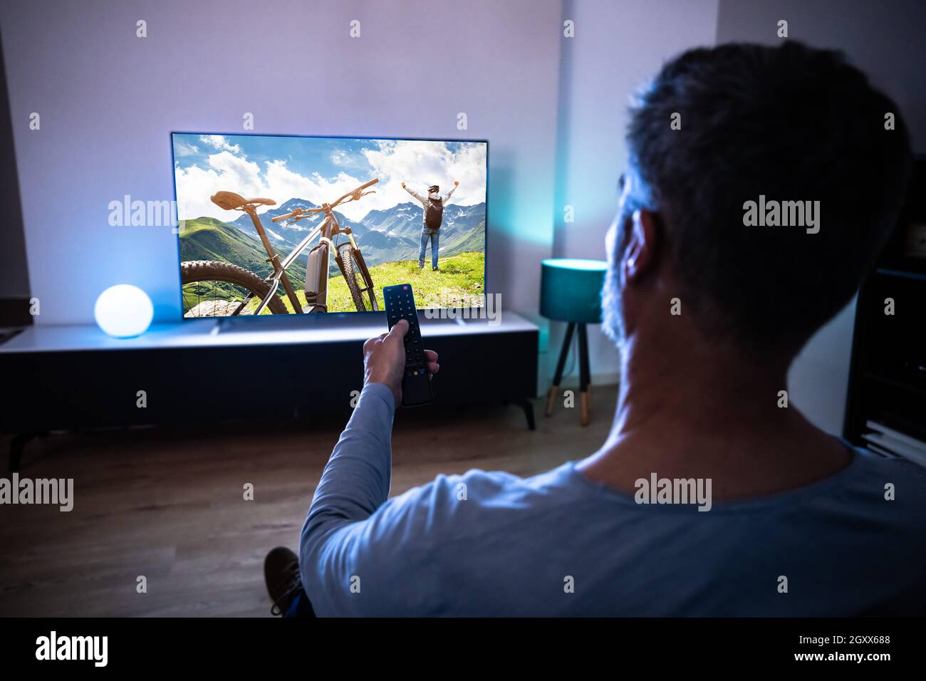 Man Watching Live TV In Room. Streaming Television Stock Photo - Alamy