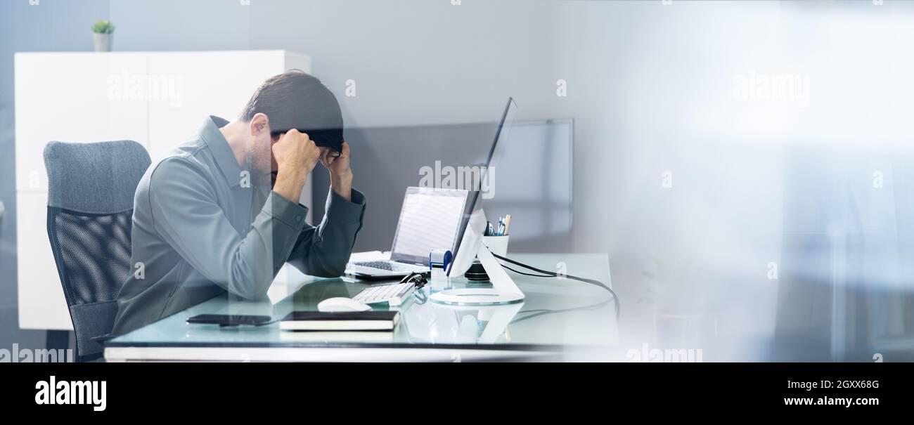 Unhappy Depressed Employee With Stress Using Computer In Office Stock ...