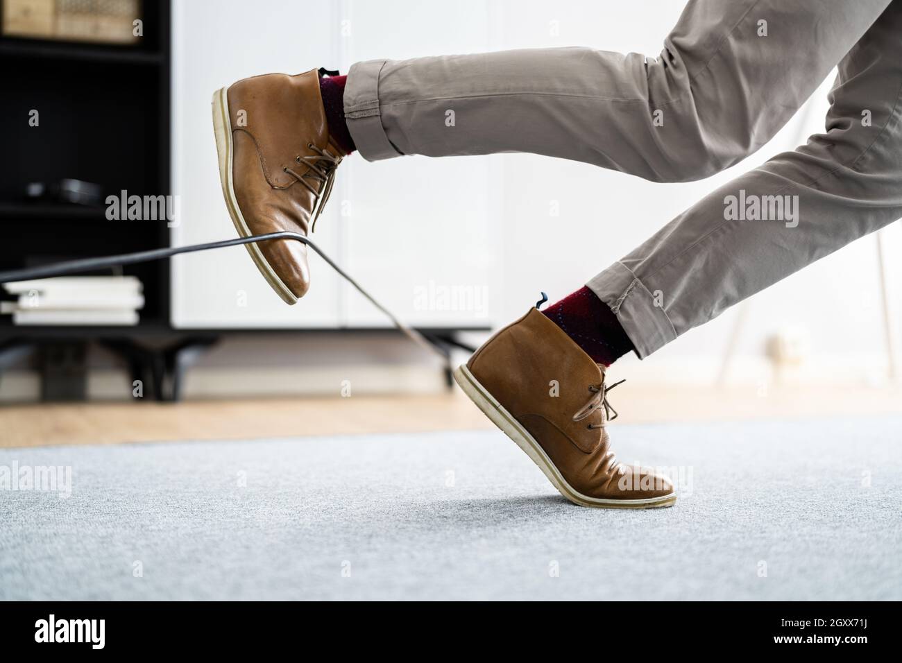 Wire Cord Trip Over And Fall. Feet Stumble On Cable Stock Photo - Alamy