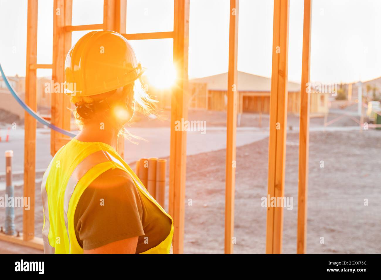 Female Construcion Worker Looking Out From New Home Framing Stock Photo ...