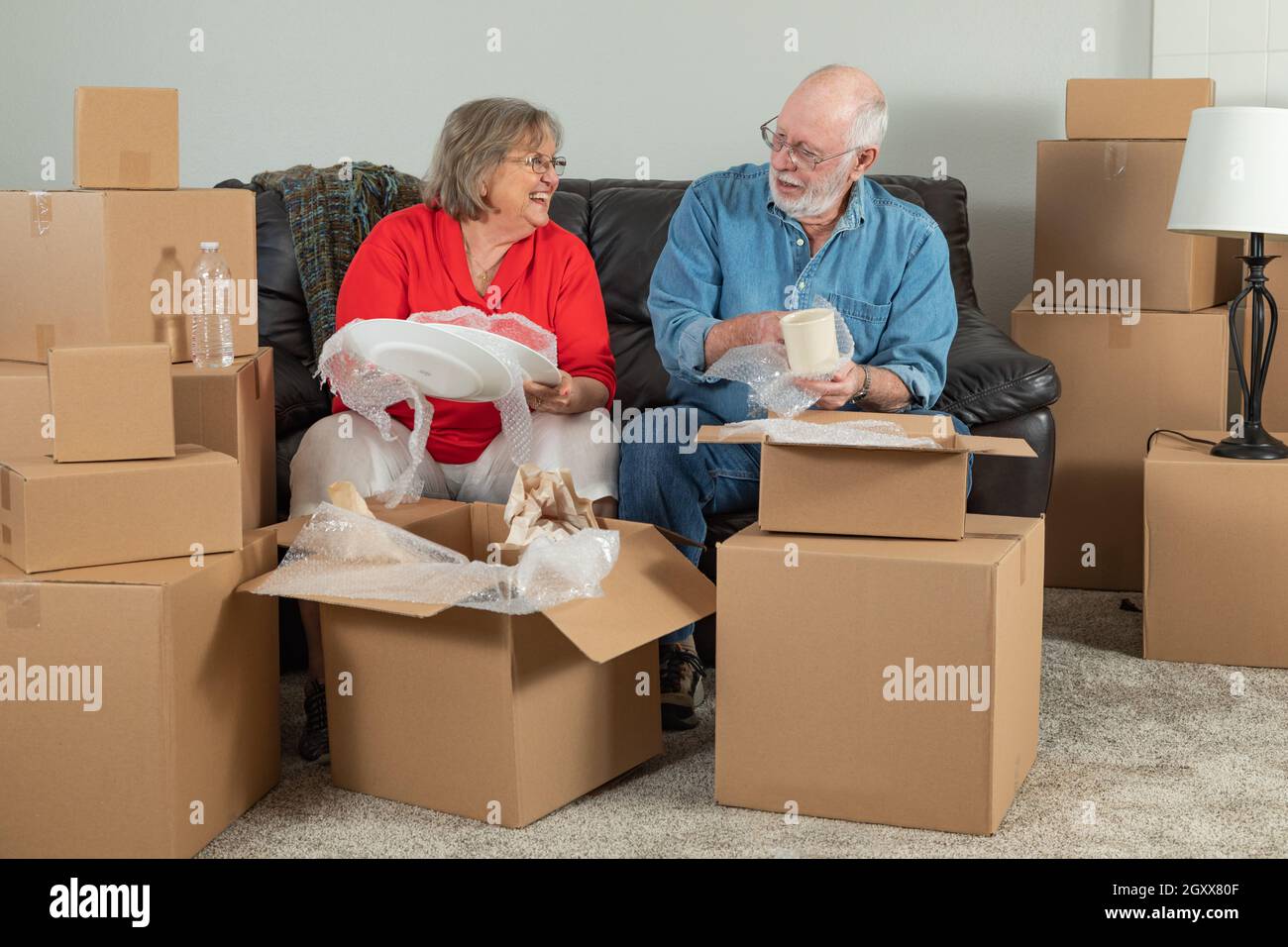 Elderly man unpacking boxes hi-res stock photography and images - Alamy