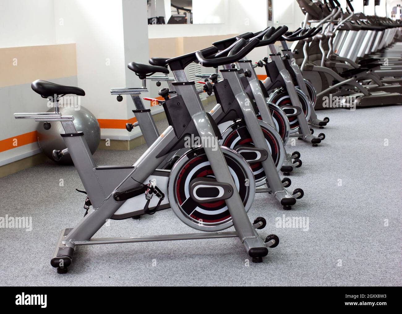 row sport's simulators and ball in gymnasium Stock Photo - Alamy