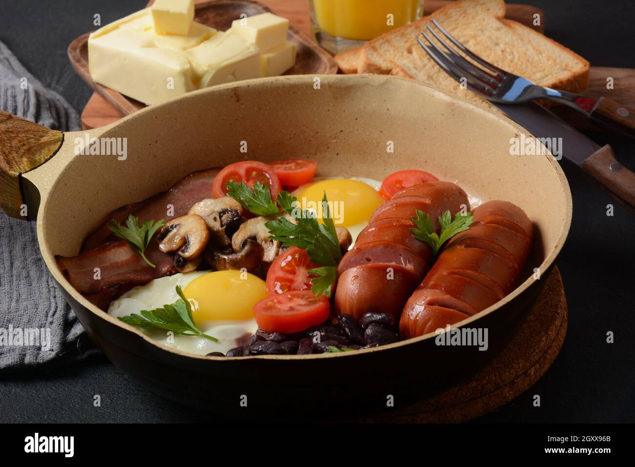 Traditional full English breakfast with bacon, fried eggs, sausages ...