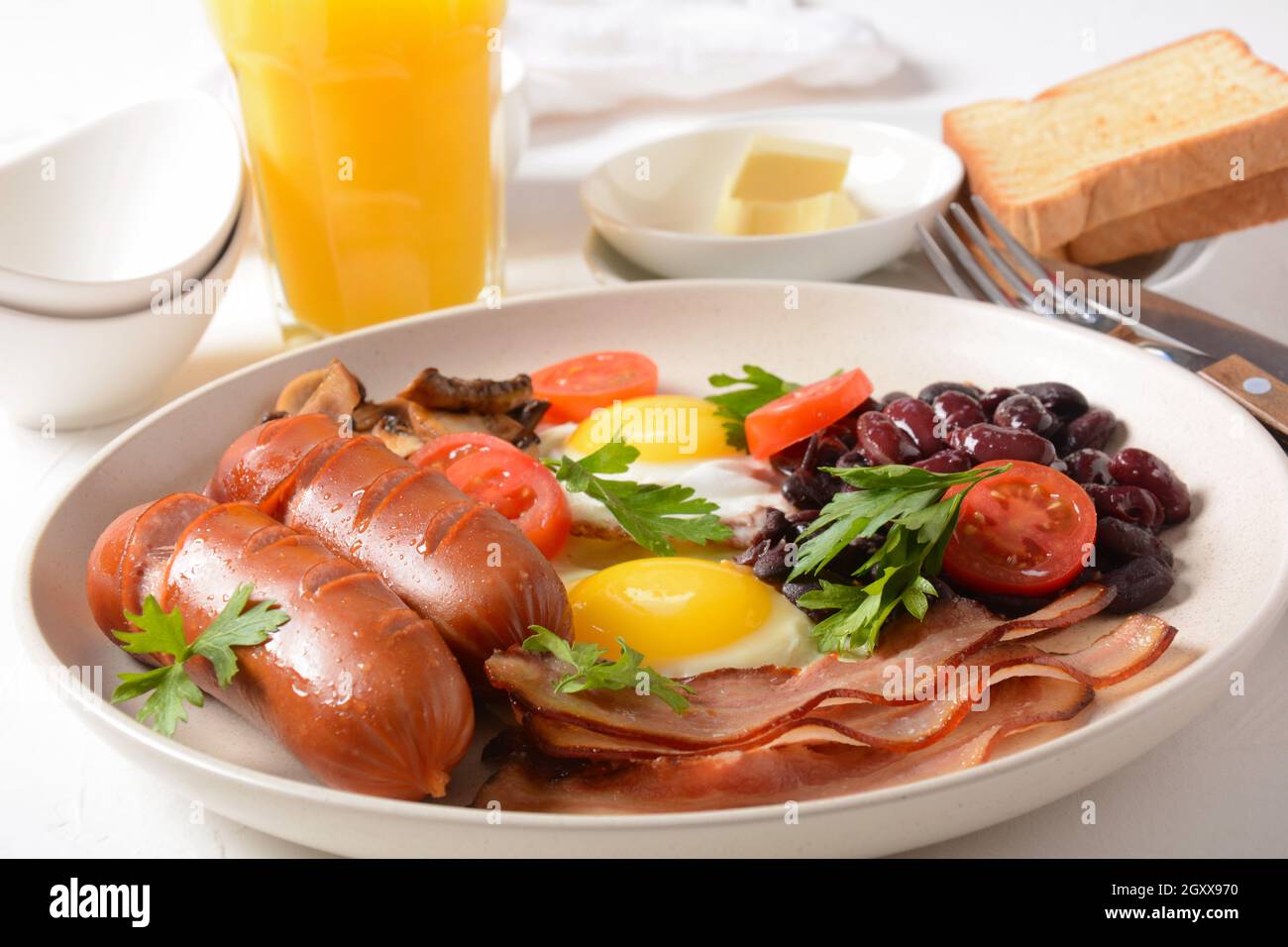 Traditional full English breakfast with bacon, fried eggs, sausages ...