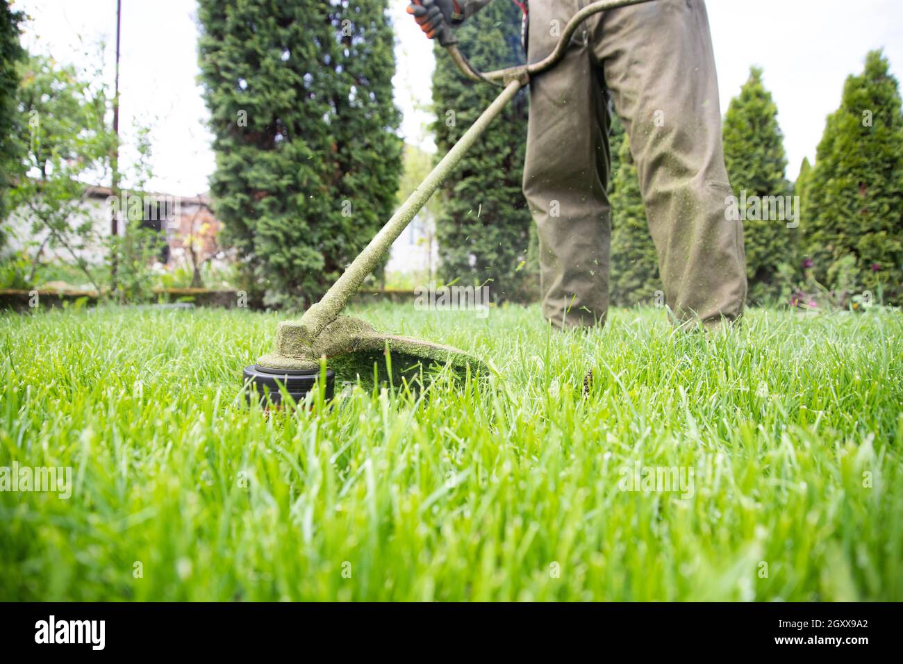 Mowing the grass with a lawn mower. Garden work concept background ...