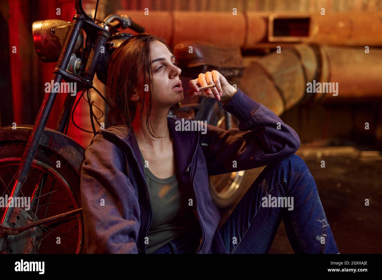 Drug addict woman smokes a cigarette while she high in den, junkie man ...