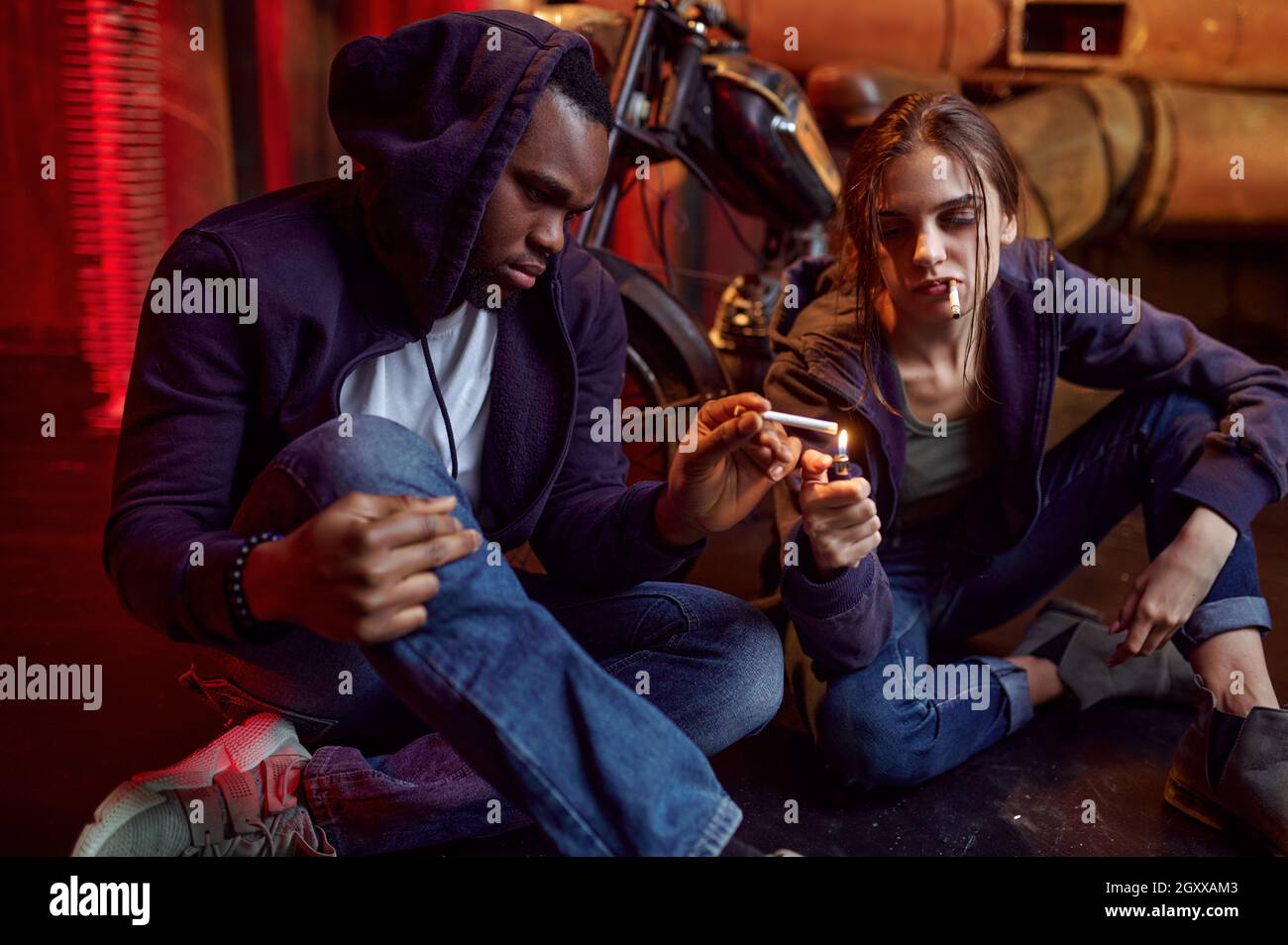 Drug addict man and woman smokes a cigarette while high in den ...