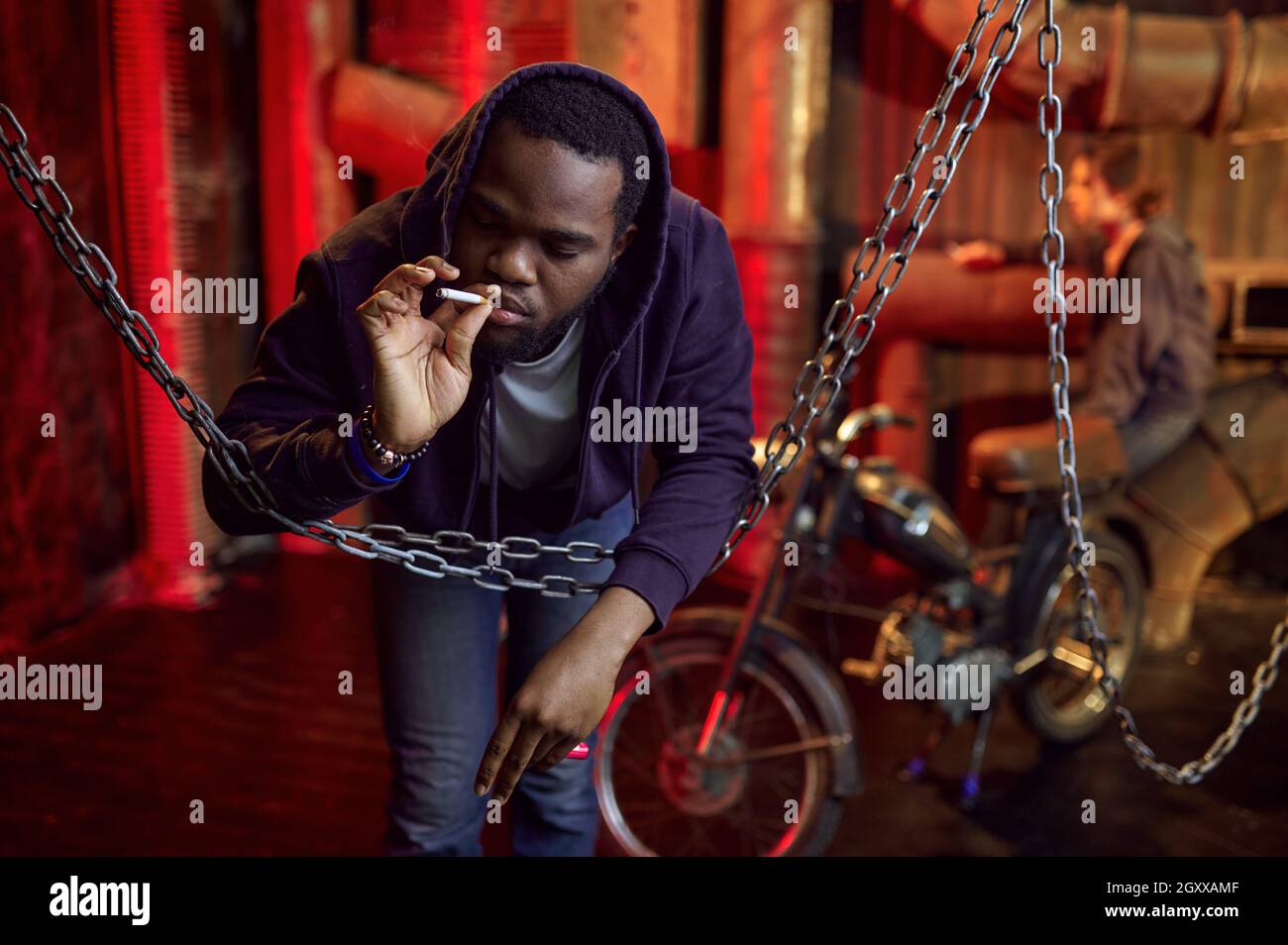 Drug addict man smokes a cigarette in den, junkie in withdrawal ...