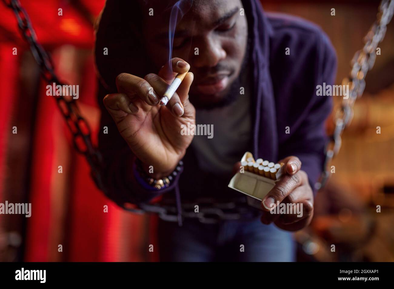 Drug addict man smokes a cigarette in den, junkie in withdrawal ...