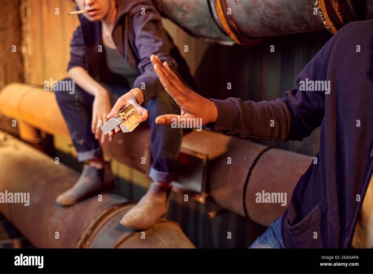 Drug addict man and woman smokes a cigarette in withdrawal, abandoned ...