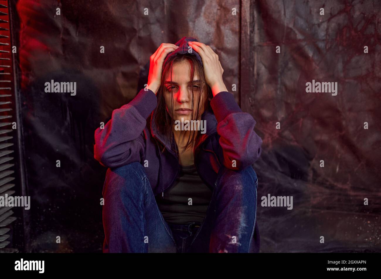 Drug addict female person in high, shebang interior on background, den ...