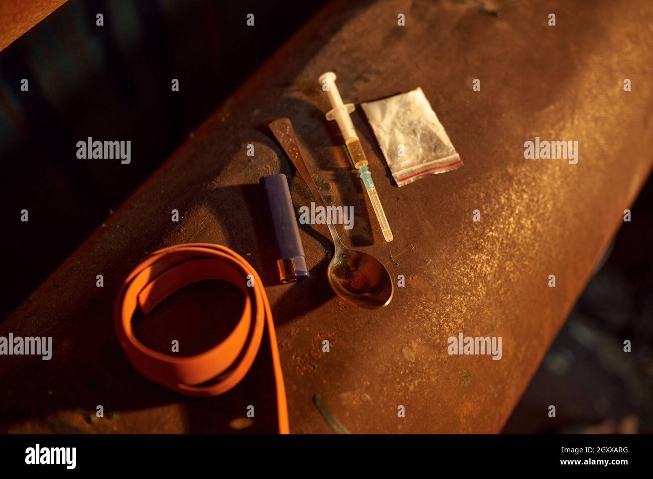 Drug addicts tools, syringe, spoon and tourniquet, powder in zip ...