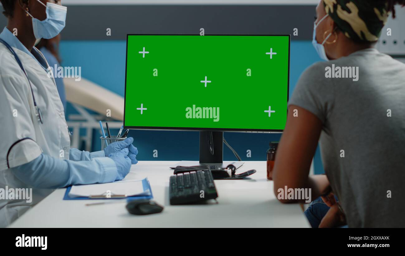 Close up of woman and doctor looking at green screen on computer. Medic ...