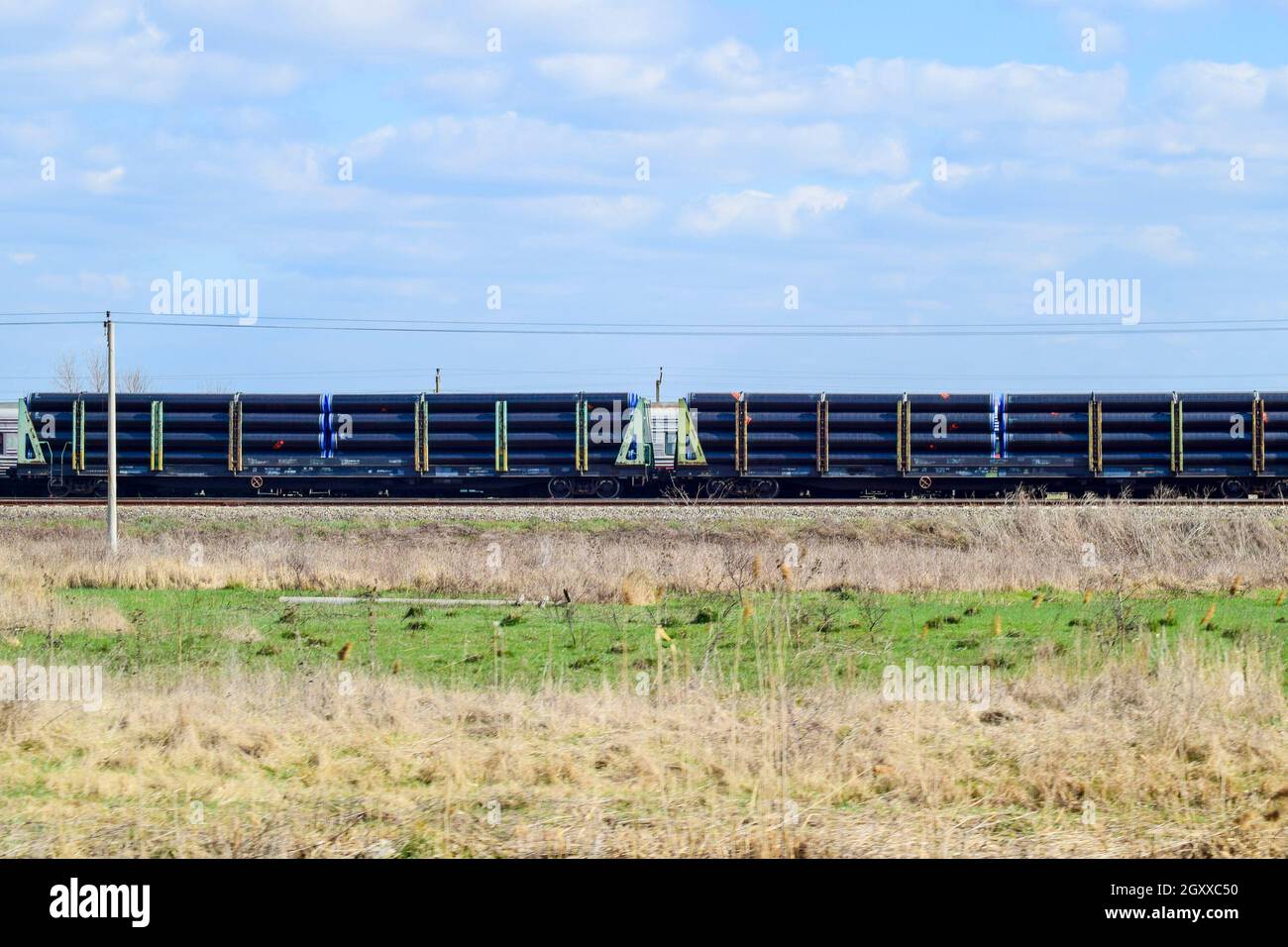 Freight train, carrying pipes for the gas pipeline and other freight ...