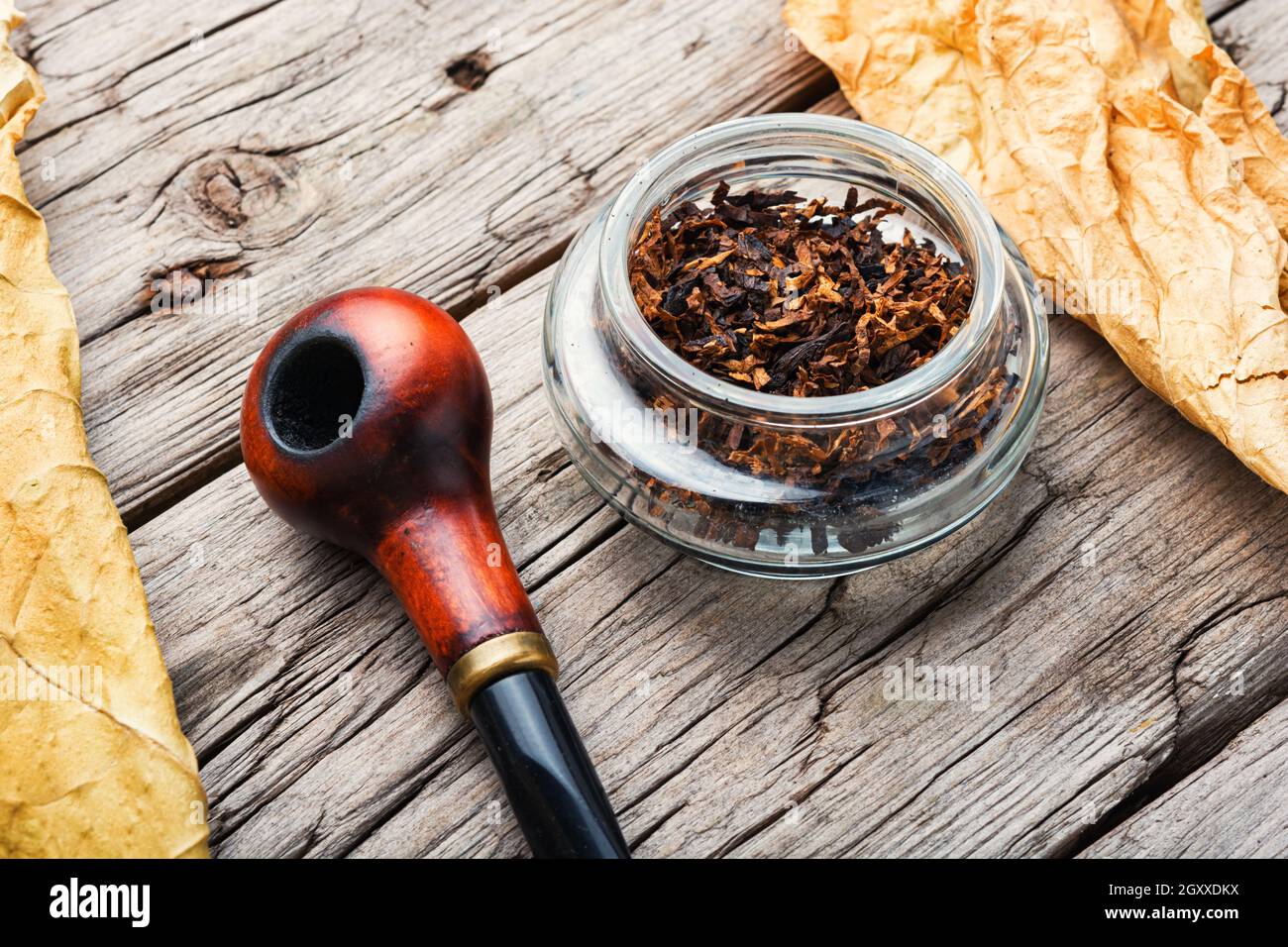 Tobacco pipe, tobacco leaf and pipe tobacco.Smoking pipe on rustic ...