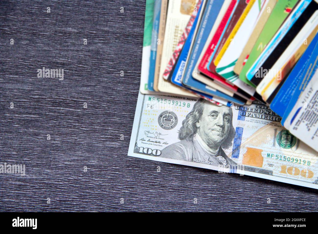 Hundred dollar note and credit cards. Pile of credit cards in dollars ...