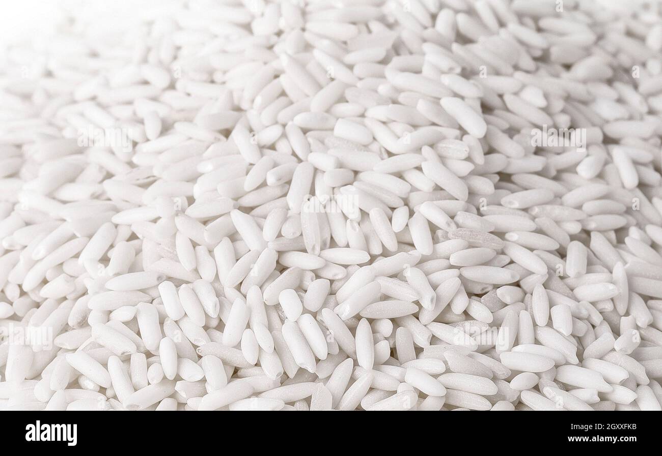 The close up white rice isolated on a white background Stock Photo - Alamy