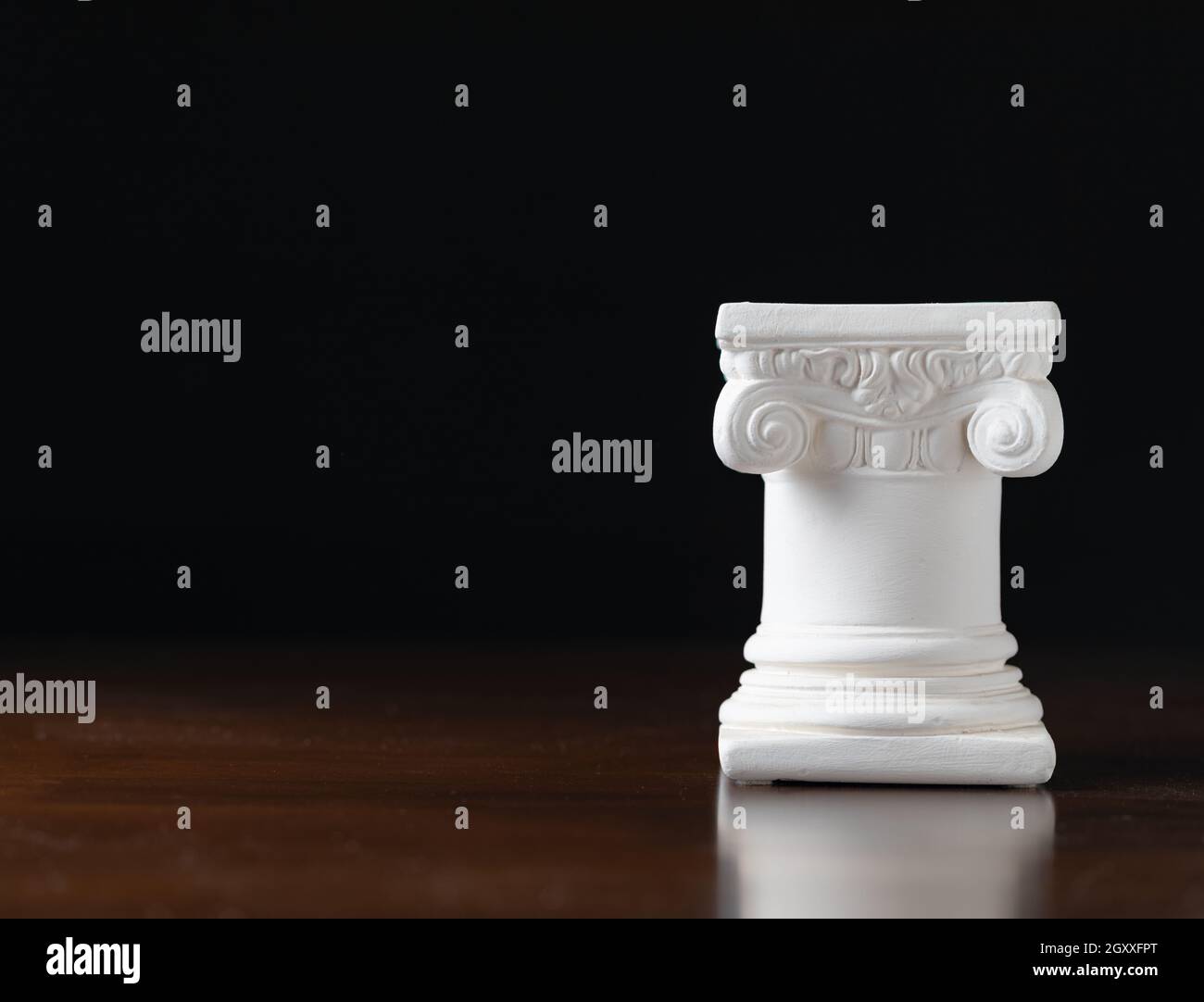 White Ionic Design Column on Dark Background Stock Photo - Alamy