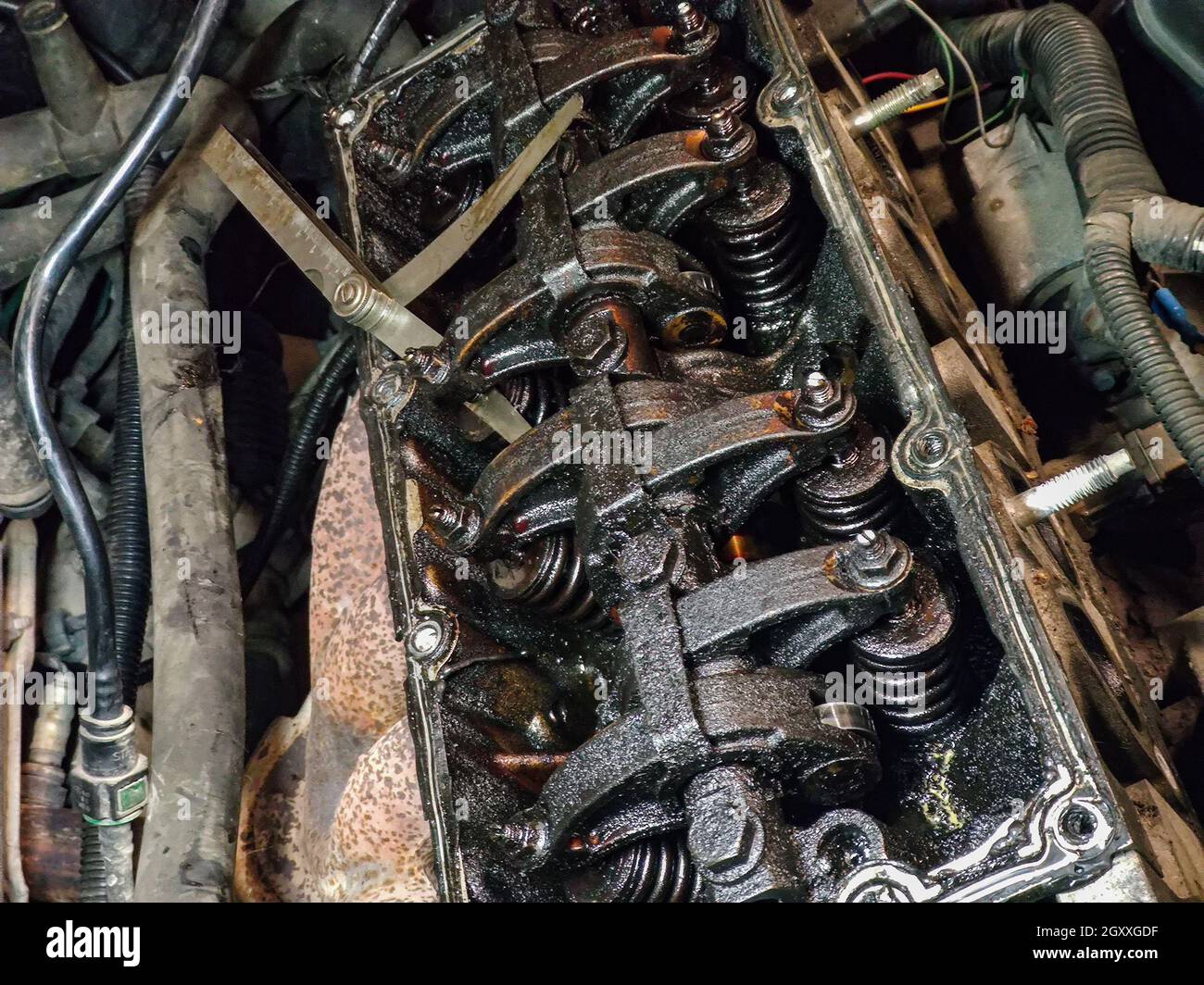 Dirty Valves and engine camshaft inside a broken engine Stock Photo - Alamy