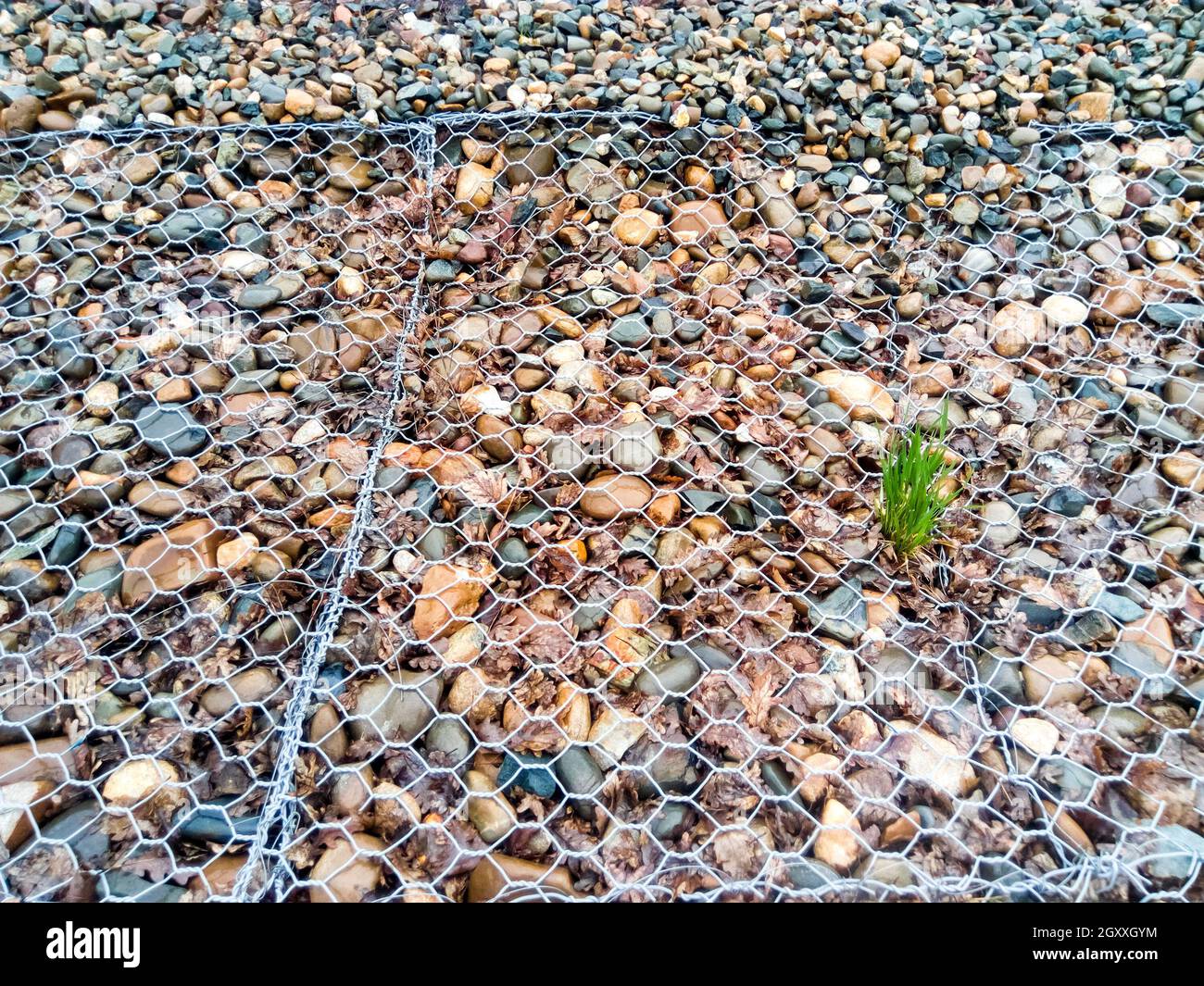 Retaining net on the slope. The net keeps the pebble from scattering ...