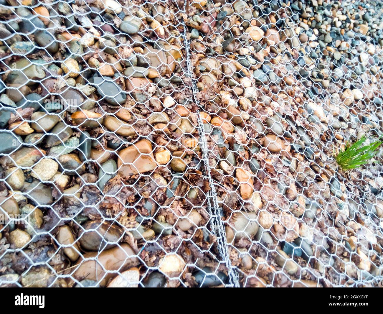 Retaining net on the slope. The net keeps the pebble from scattering ...
