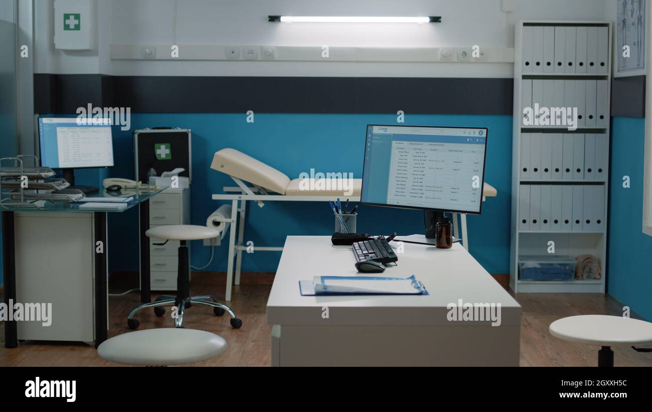 Empty doctors office with medical equipment and computer on desk at ...