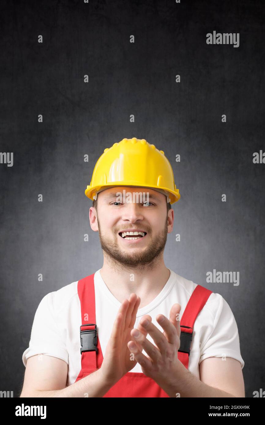 Happy, smiling construction worker clapping his hands Stock Photo - Alamy