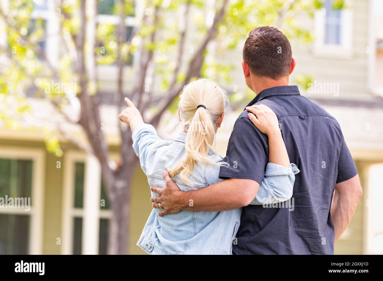 Woman outside pointing at house hi-res stock photography and images - Alamy