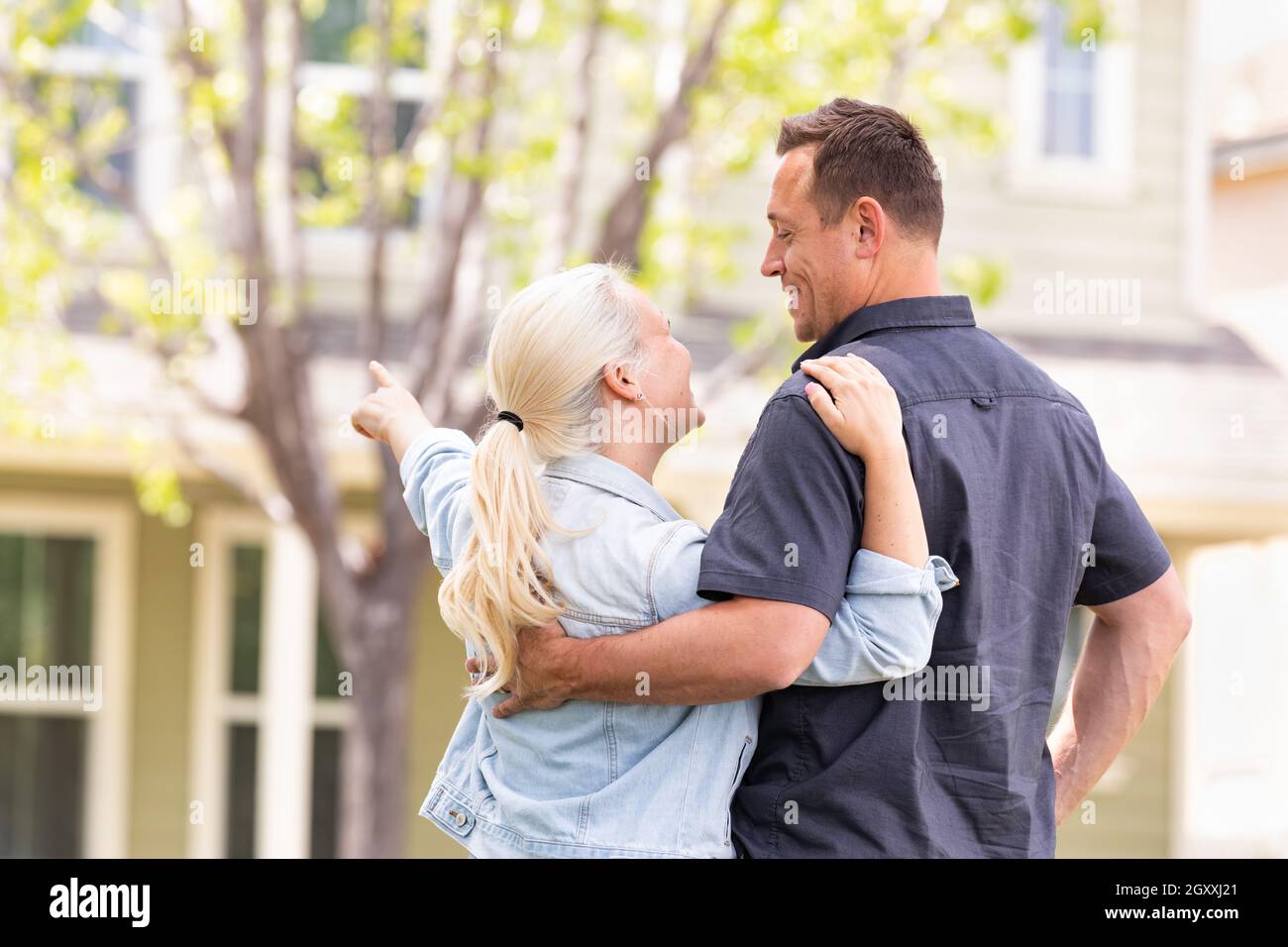 Woman outside pointing at house hi-res stock photography and images - Alamy
