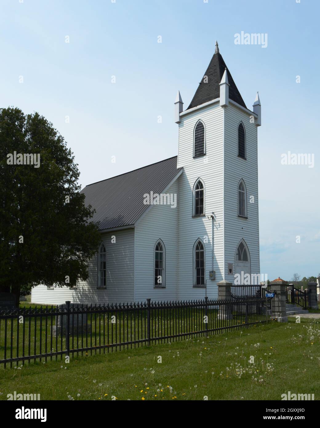 A beautiful white Church exterior on a grass and sky environment during ...