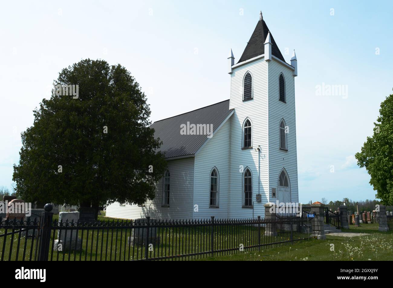 A beautiful white Church exterior on a grass and sky environment during ...