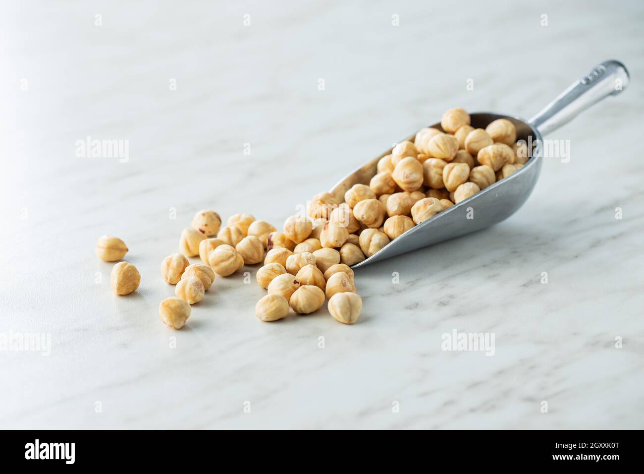 Peeled roasted hazelnut kernels in metal scoop Stock Photo - Alamy