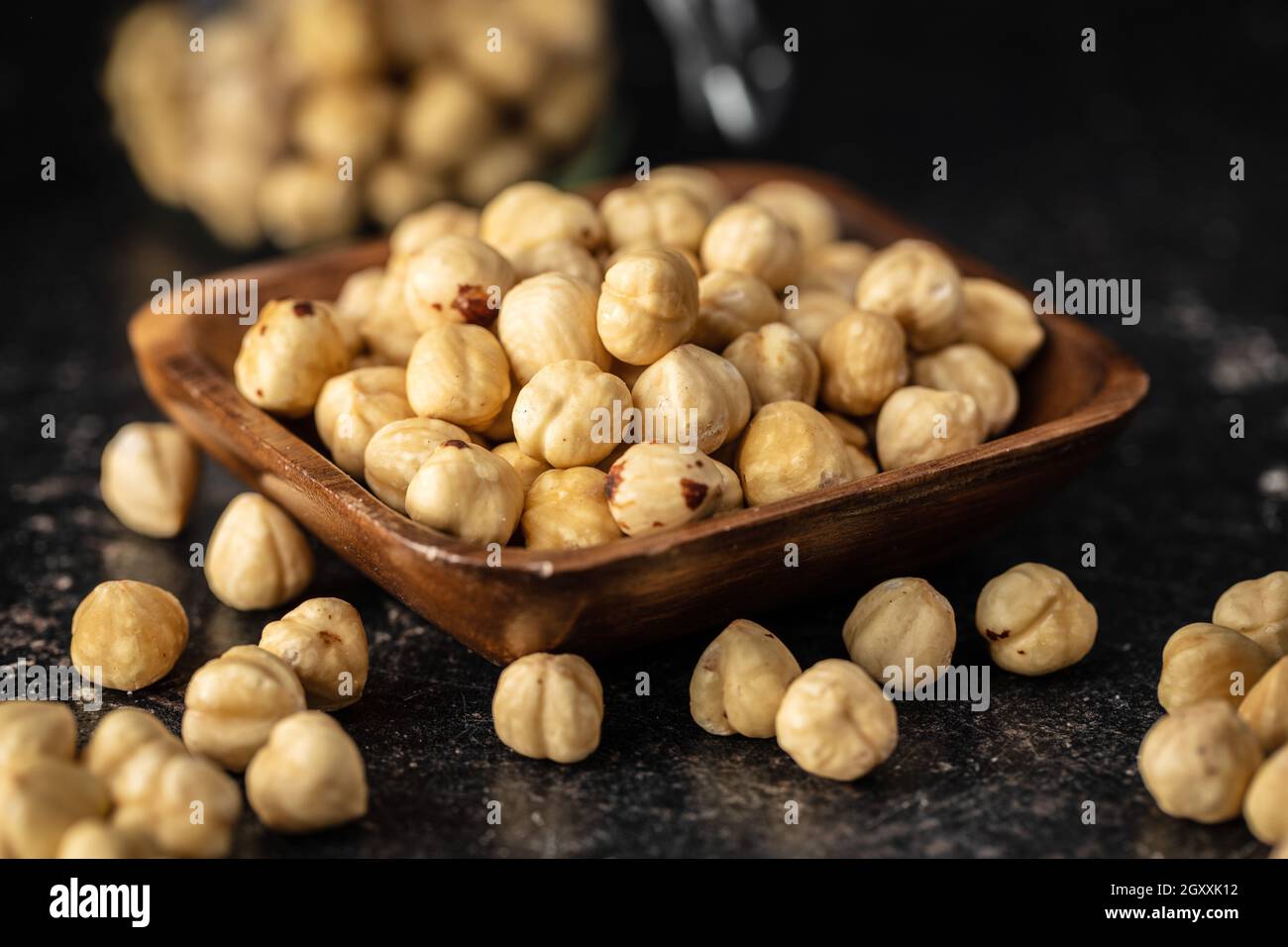 Peeled roasted hazelnut kernels in wooden bowl Stock Photo - Alamy