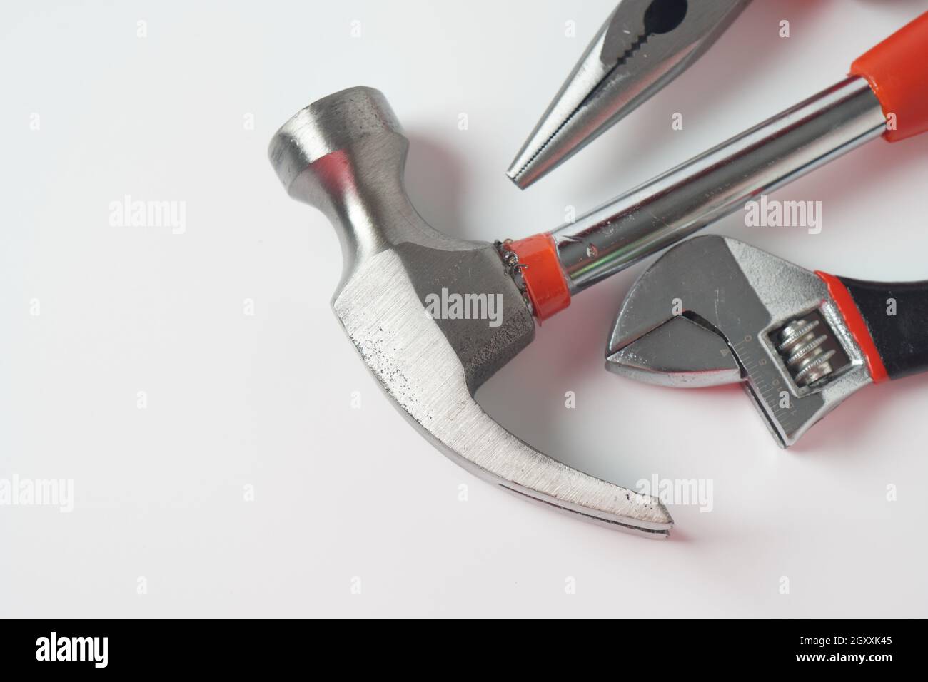 Hammer and Pliers and Adjustable wrench on white background. Close up ...