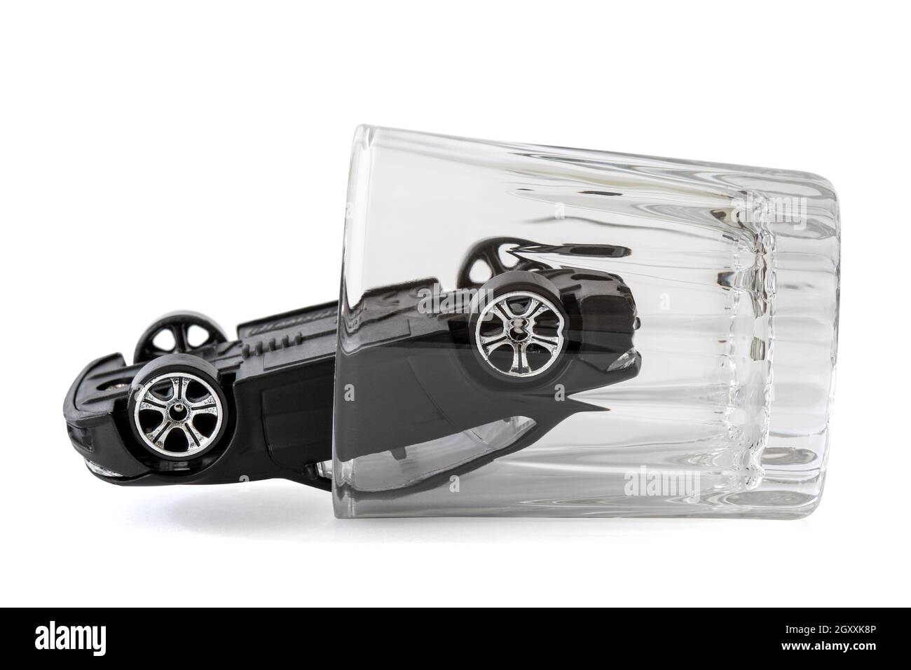 Toy car in a vodka glass isolated on white background. Drunk driving ...