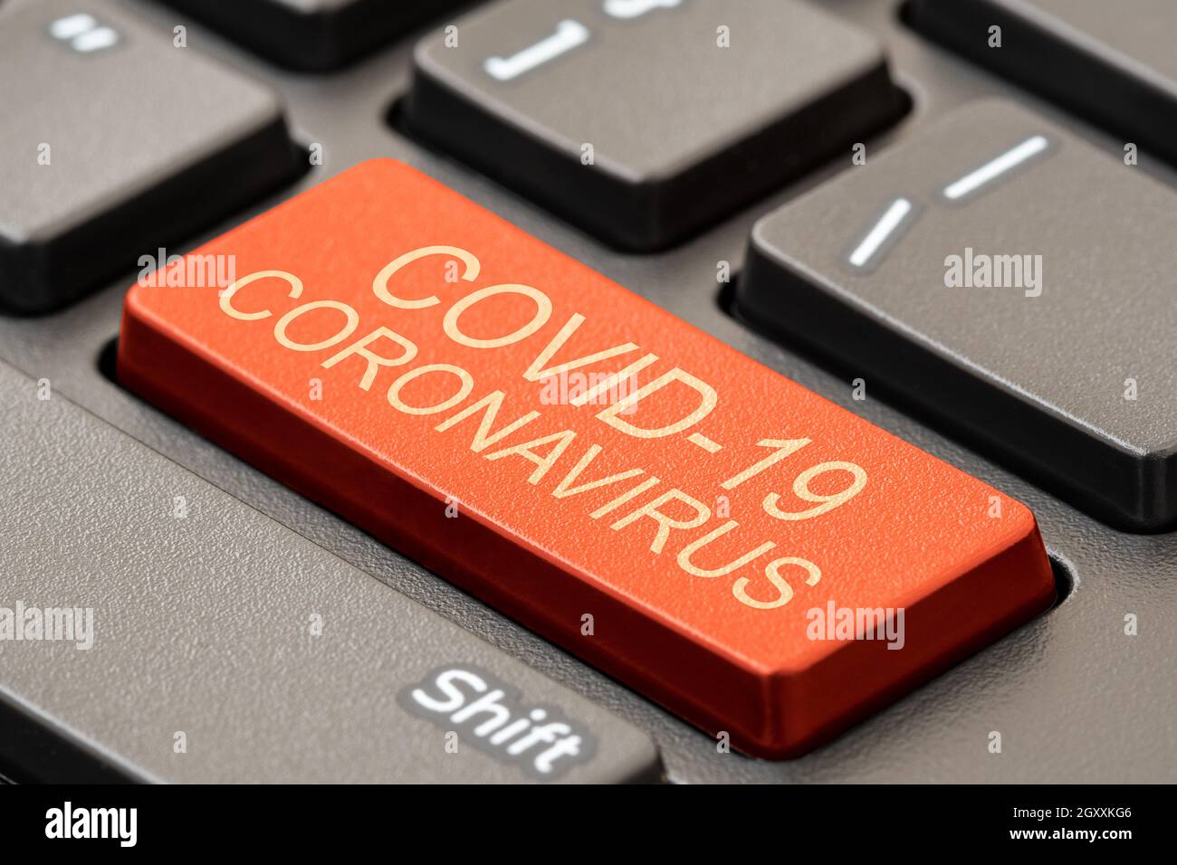 Corona Virus keyboard with a single large red key on a black computer ...