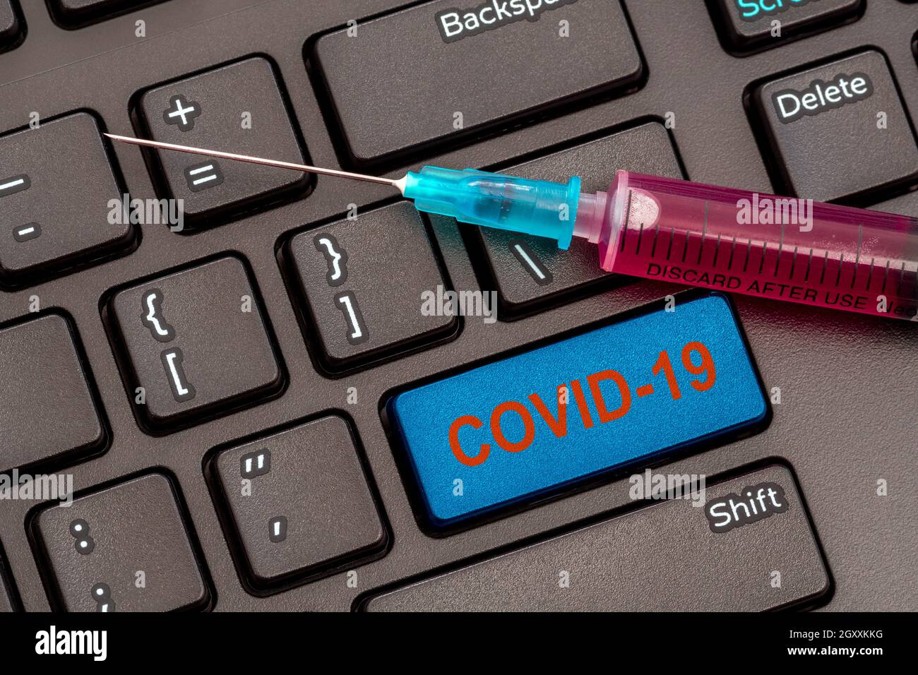 Vaccine and syringe injection on computer keyboard. It use for ...