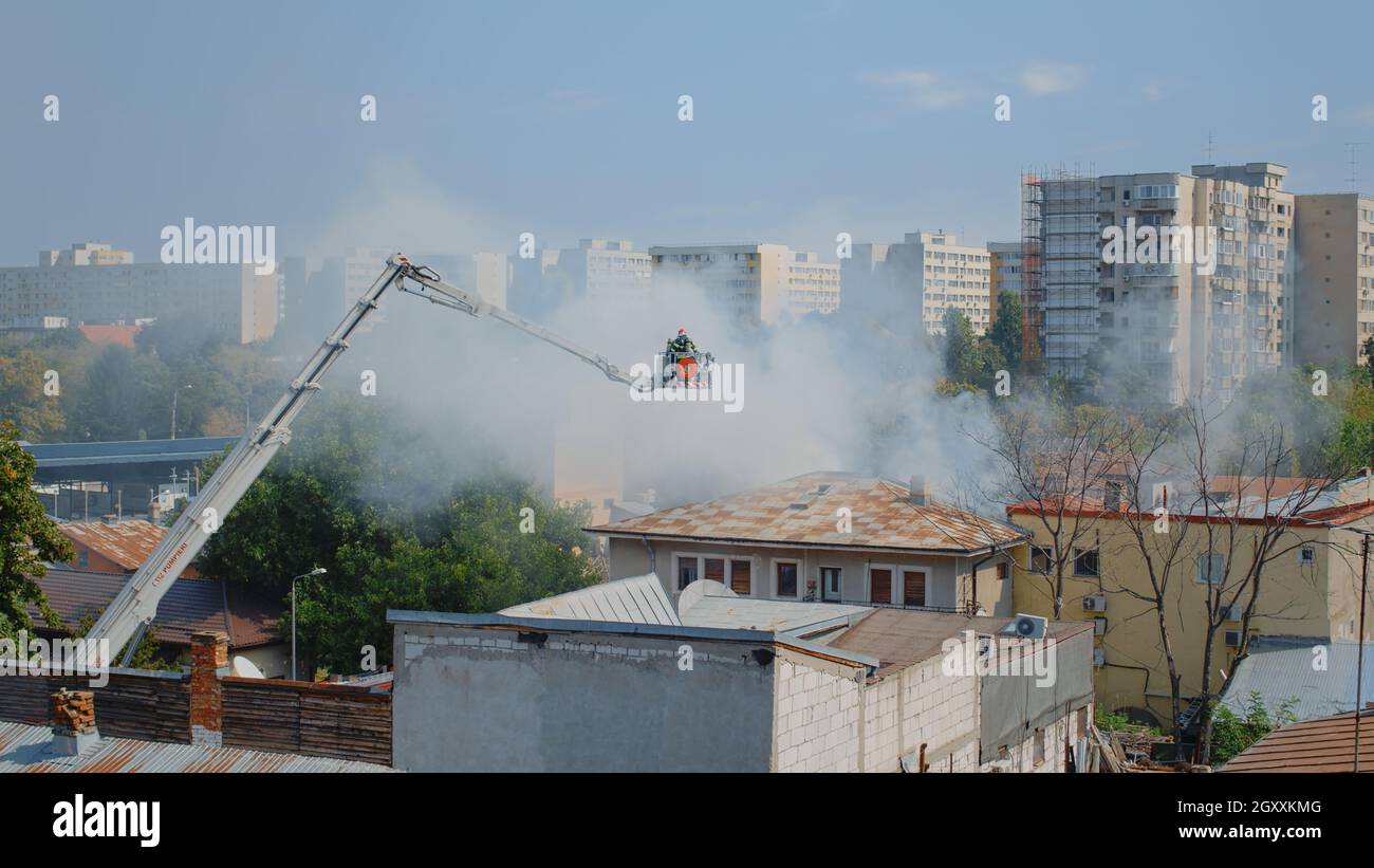 Team of firefighters on service to put out fire from burning house in ...