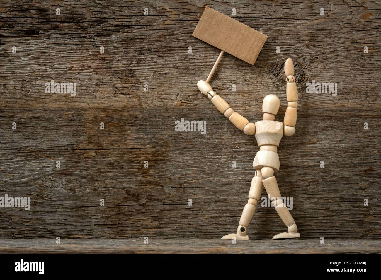 Dummy holding blank banner mock up on wood stick. Man with placard ...