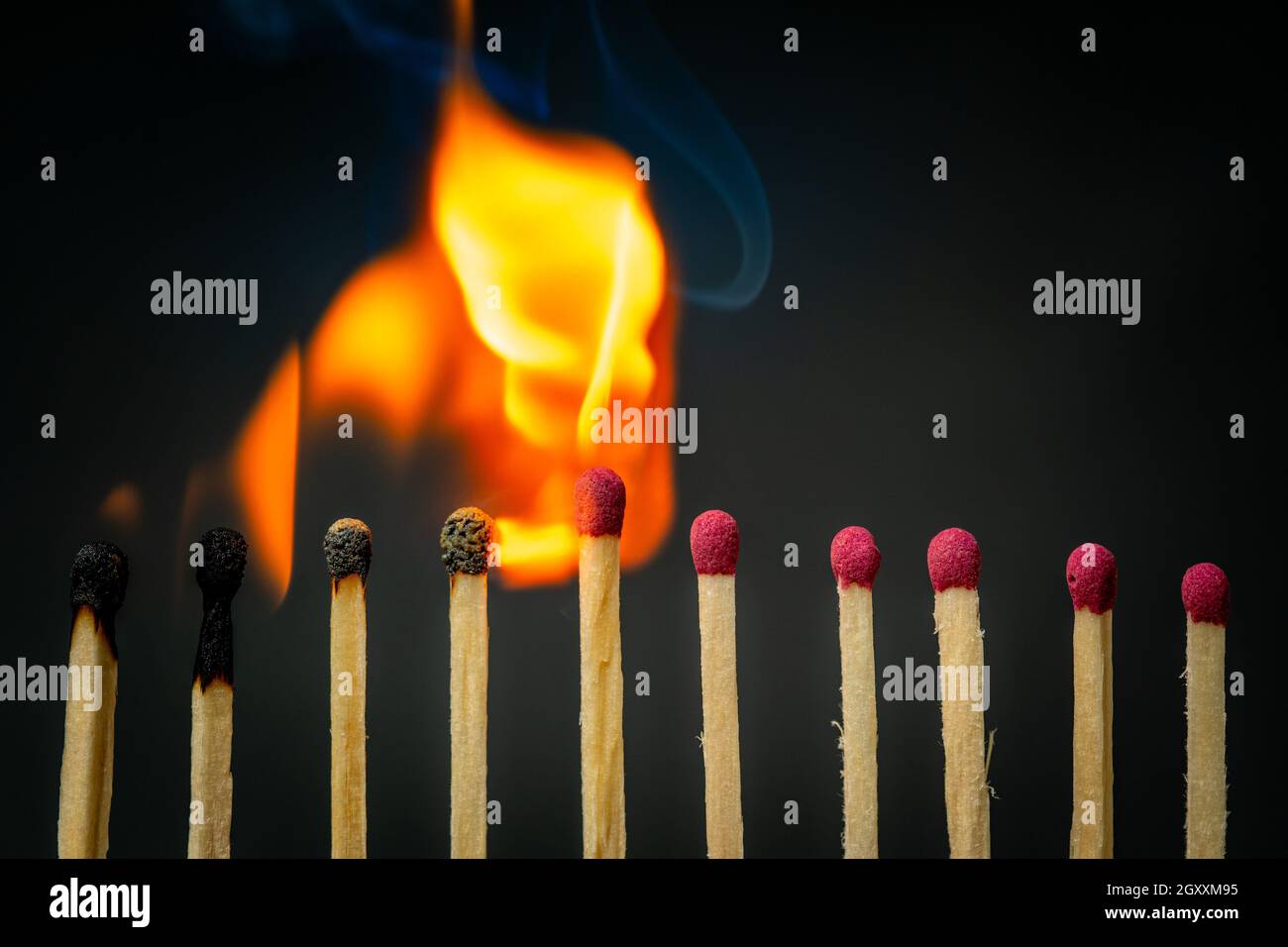 The stages of match burning on a dark background. Safety matches with ...