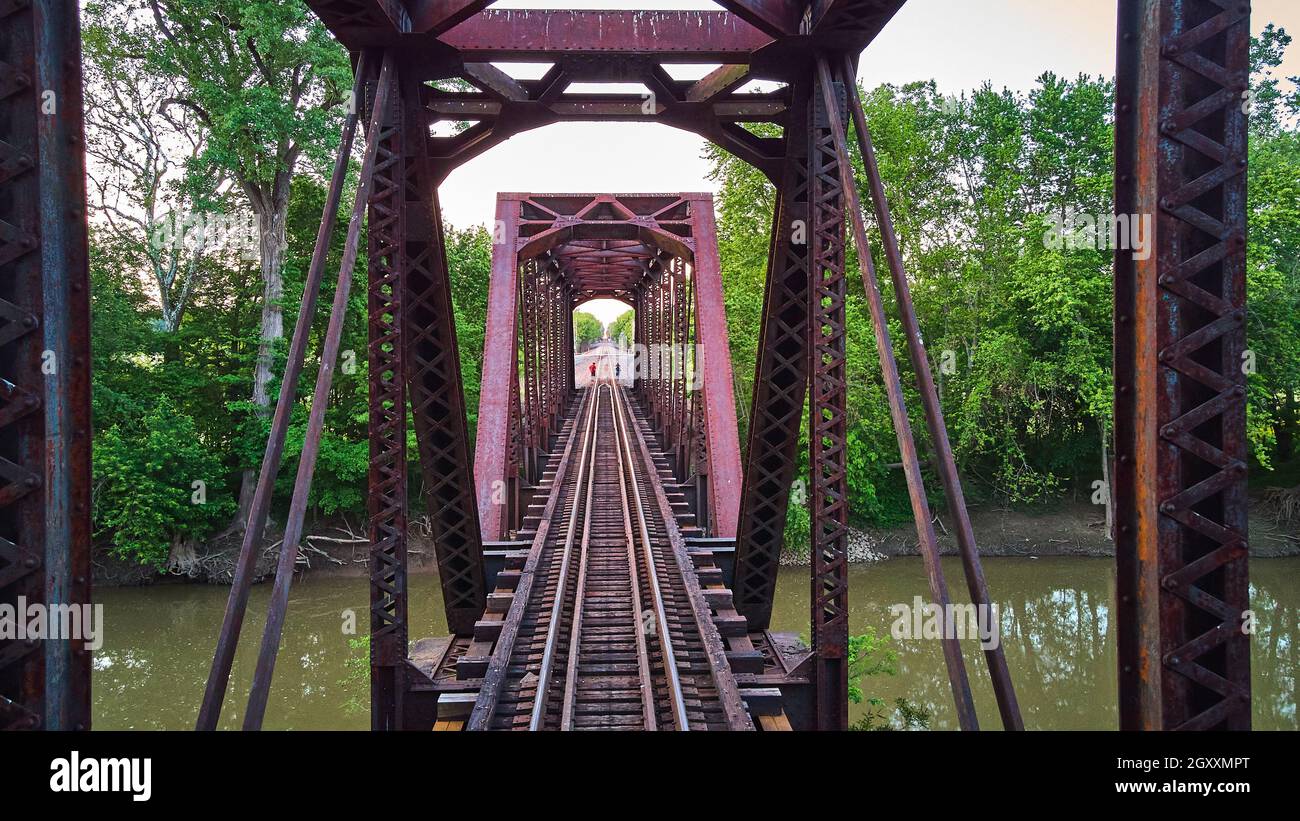 Aerial inside of metal bridge for train tracks over river Stock Photo ...