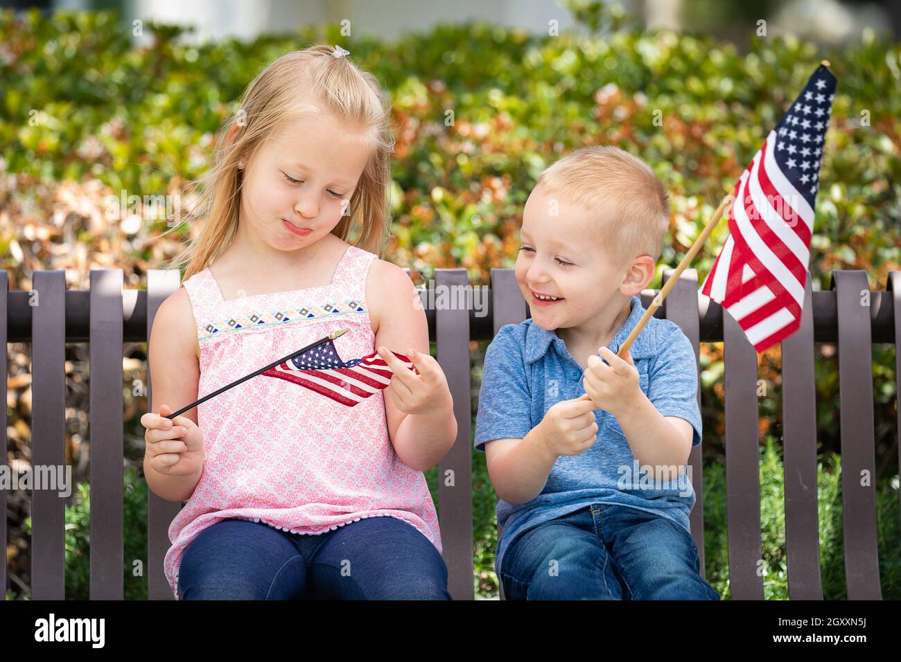 Young Sister and Brother Comparing Each Others American Flag Size On ...