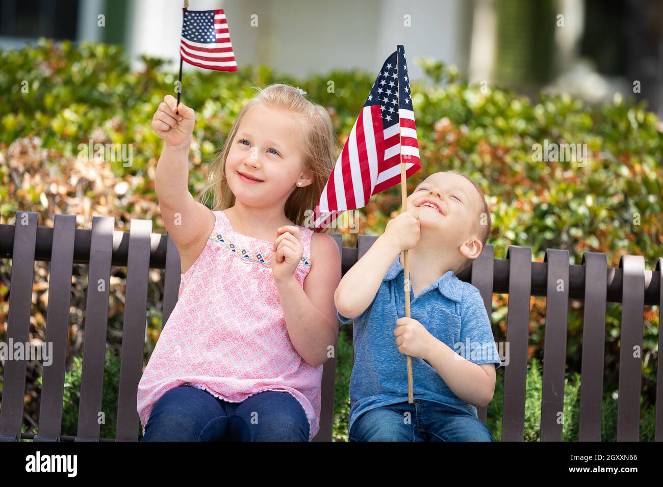 Young Sister and Brother Comparing Each Others American Flag Size On ...