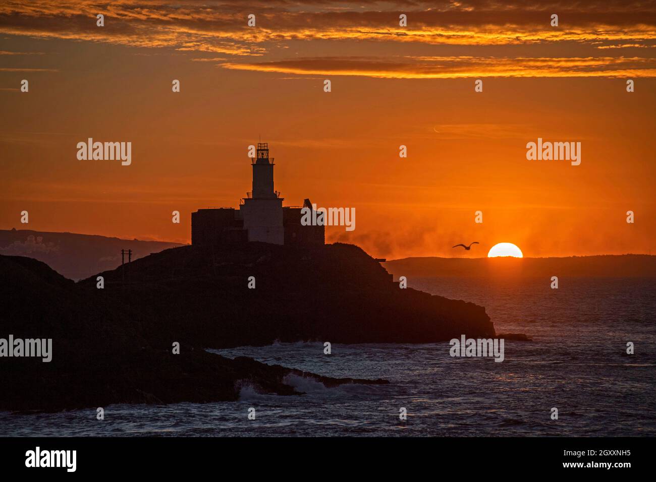 Swansea, UK. 06th Oct, 2021. The sun rises alongside the Mumbles ...