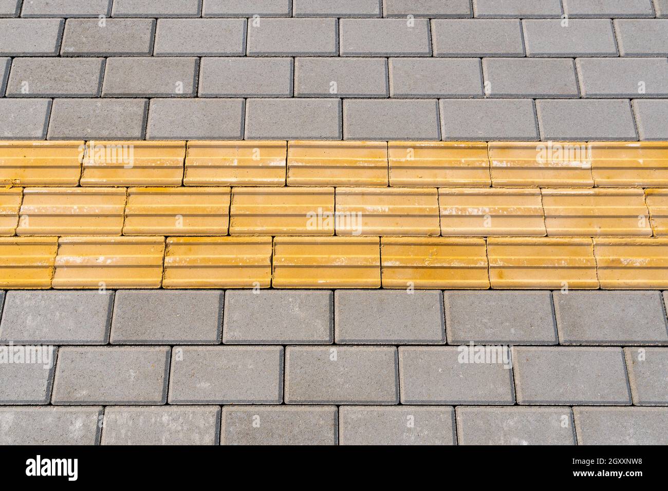 Tactile paving for blind handicap on tiles pathway, walkway for ...