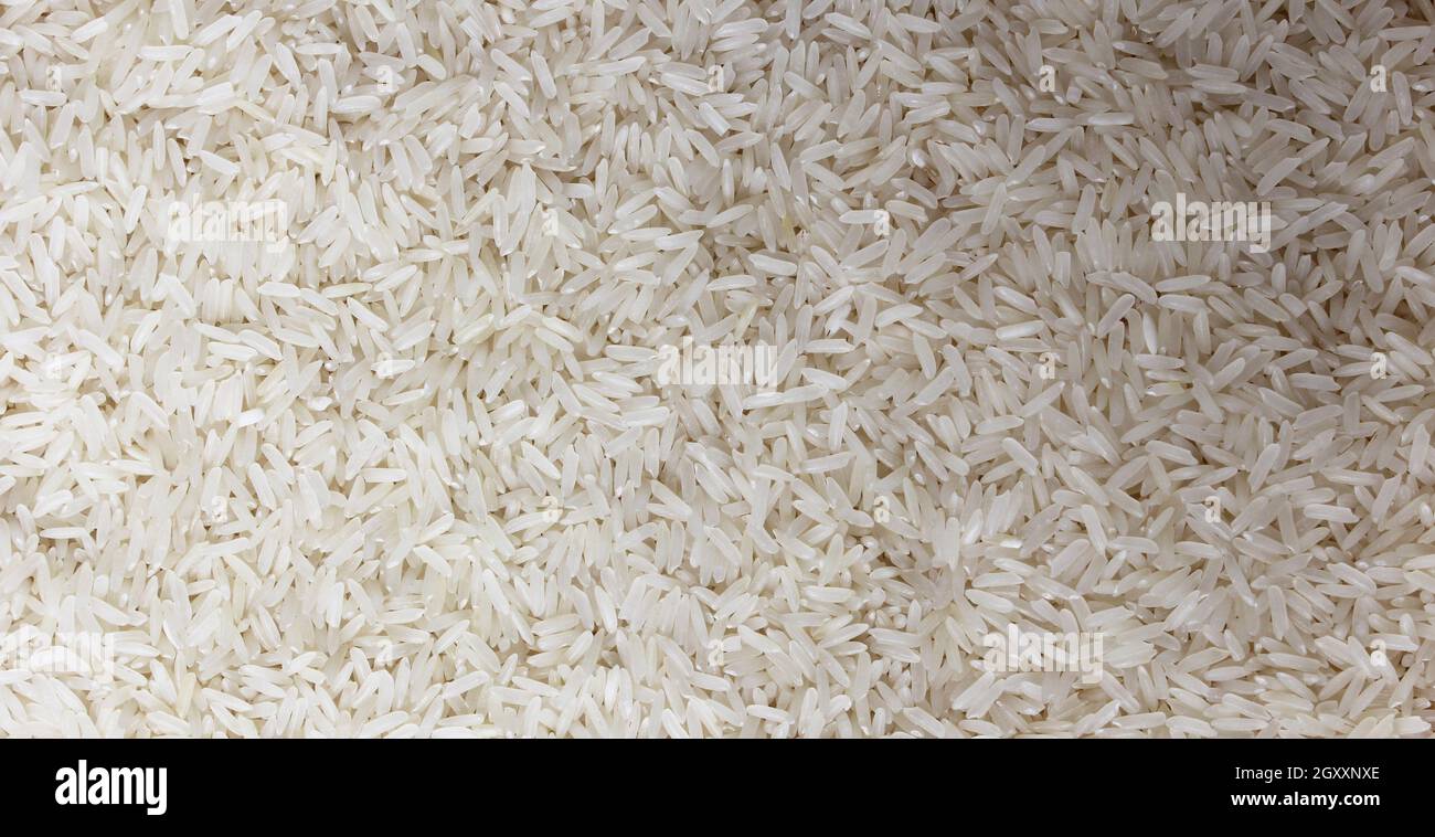 Bowl of Uncooked White Rice with leaf on bamboo mat Stock Photo - Alamy